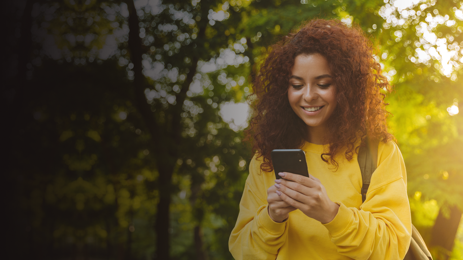 Woman texting sunny - RCB Bank