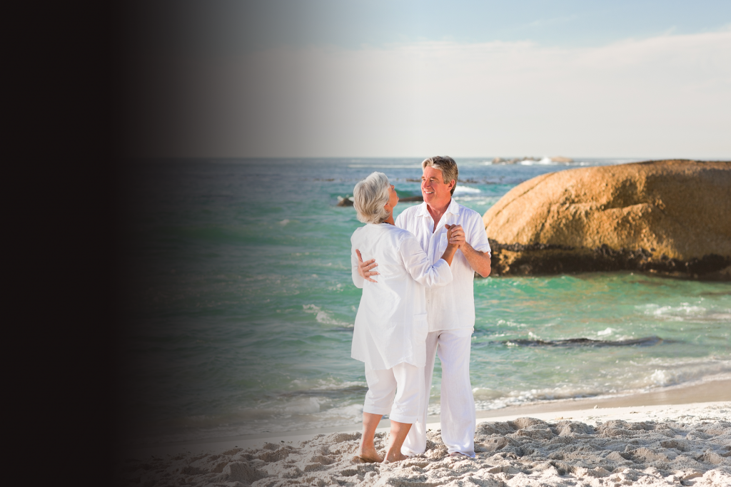 senior couple dancing on beach - RCB Bank